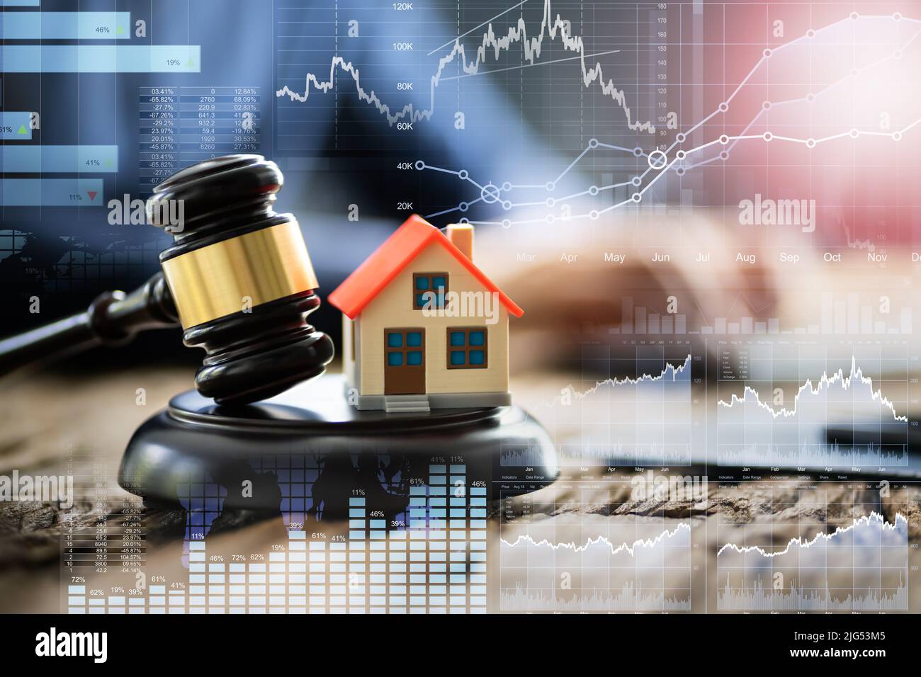 House Model With Gavel In Front Of A Businessperson Using Laptop On ...