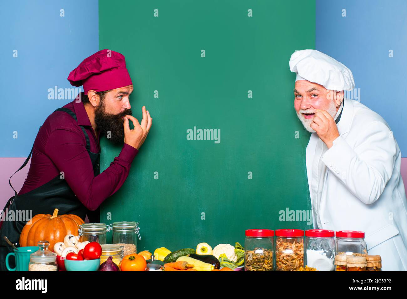 Two smiling male chefs, cooks or bakers with menu blank board. Perfect ...