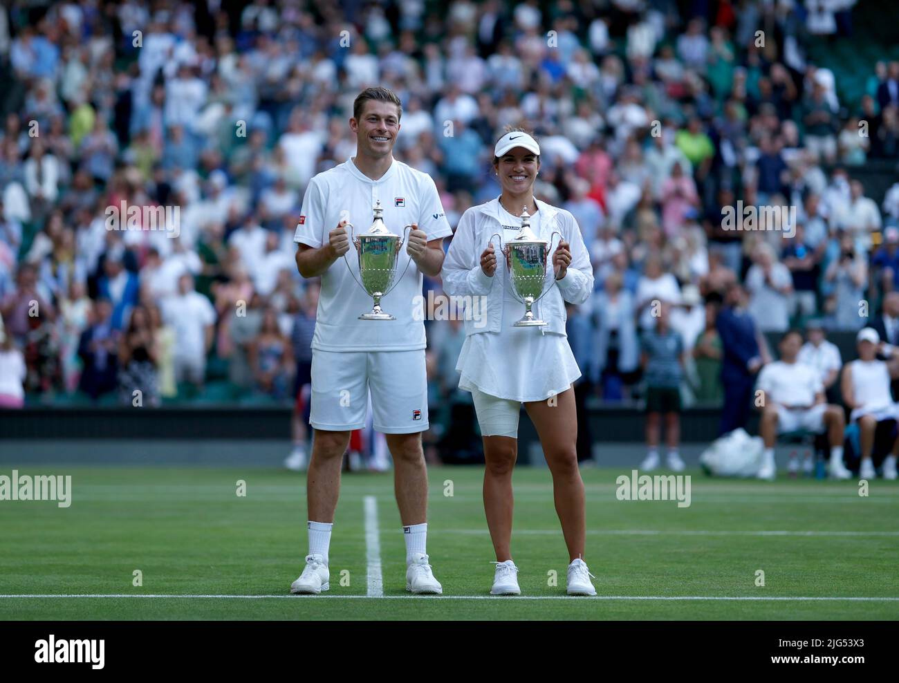 Neal Skupsk and Desirae Krawczyk pose with their trophies after winning ...