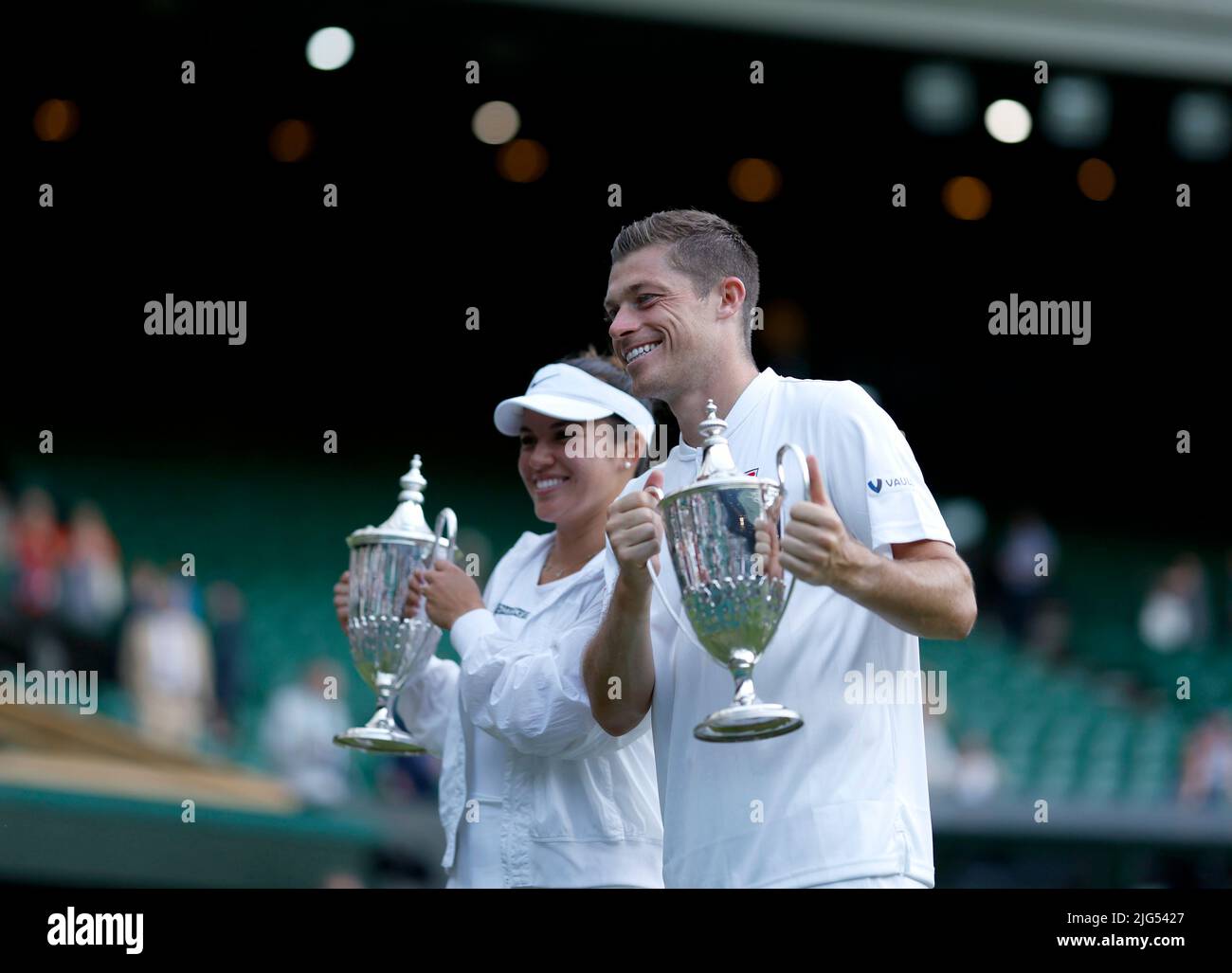 Neal Skupsk and Desirae Krawczyk celebrate with their trophies after ...