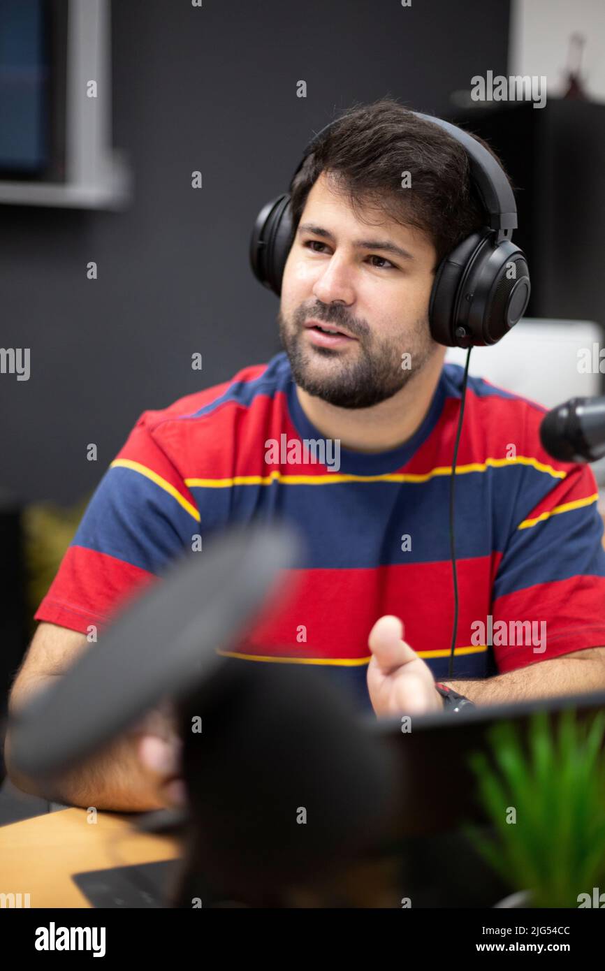 Portrait of young caucasian male with headphones in recording studio ...