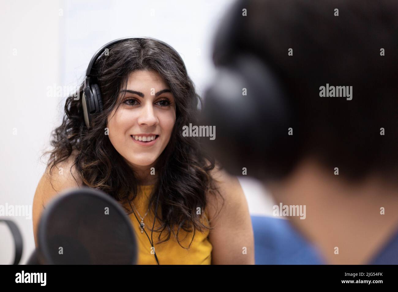 Close-up of smiling caucasian female radio announcer having a ...