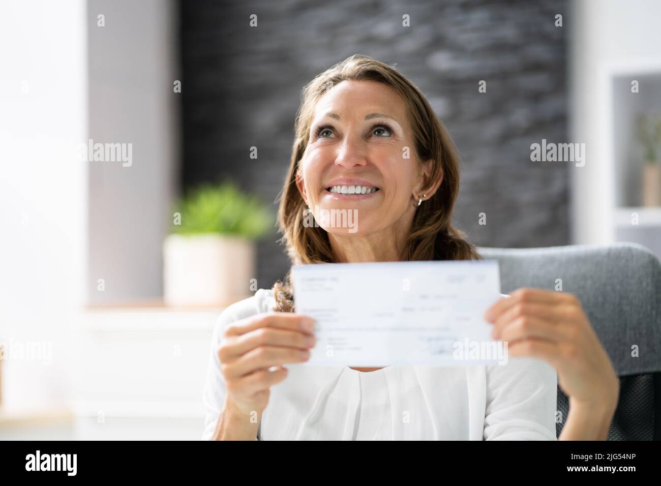 Close-up Of A Smiling Businesswoman Showing Company Cheque Stock Photo ...