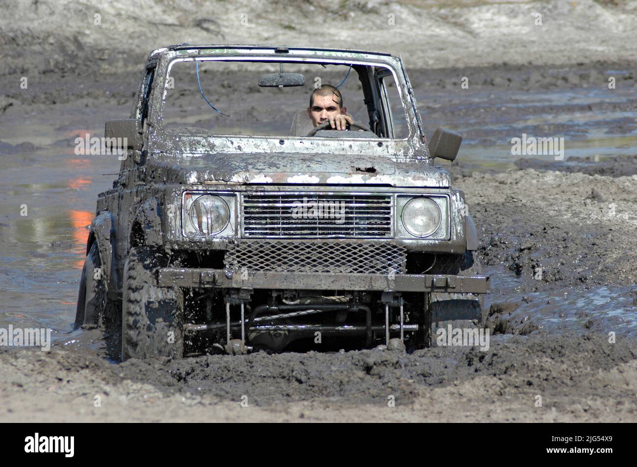 People with 4 wheelers and trucks on Sunday outing in the mud for fun ...