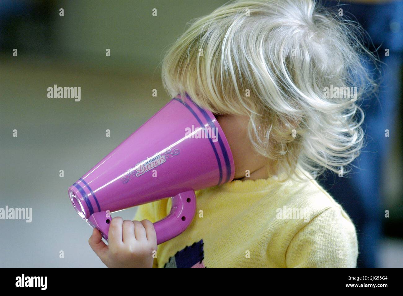Young girl cheerleader with megaphone playing on sideline blond 3 4 ...