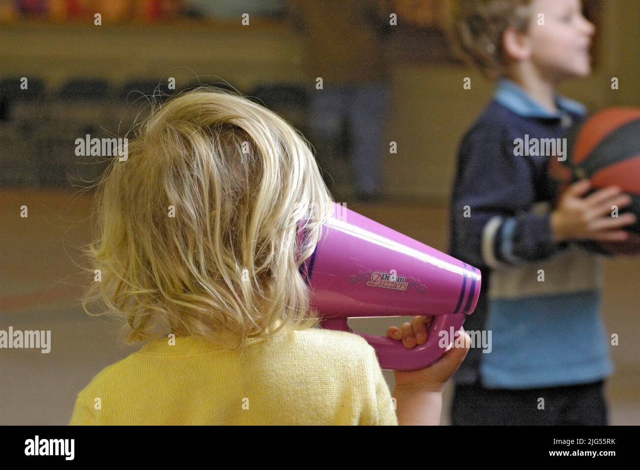 Young girl cheerleader with megaphone playing on sideline blond 3 4 ...