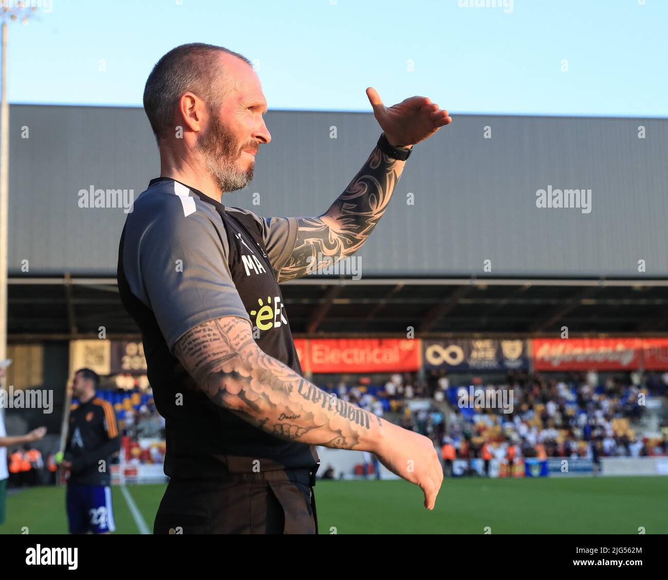 Michael Appleton head coach of Blackpool looks on as the sun dazzles ...