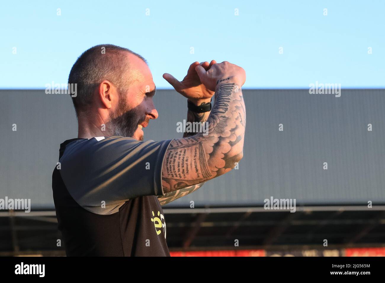 Michael Appleton head coach of Blackpool looks on as the sun dazzles ...