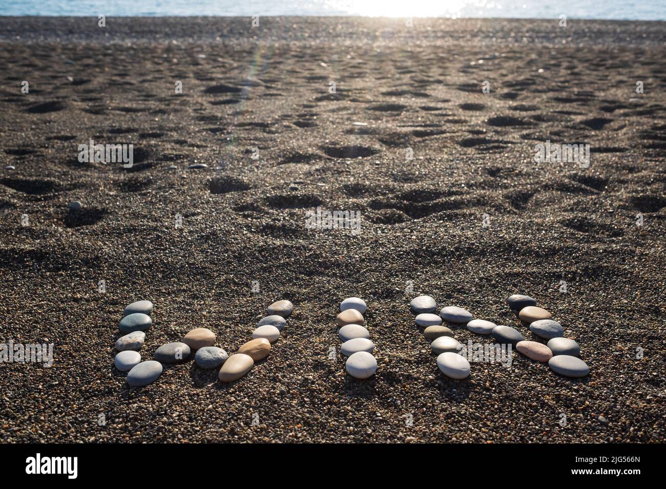 Word win made from stones on sandy beach. Success concept Stock Photo ...