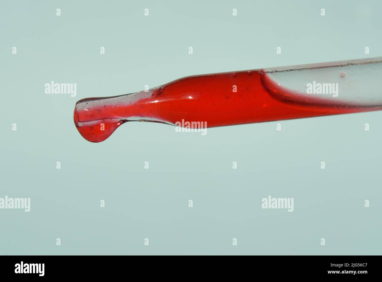 Bright red acrylic paint in a pipette.The fluid art of ebru. Mixing of ...