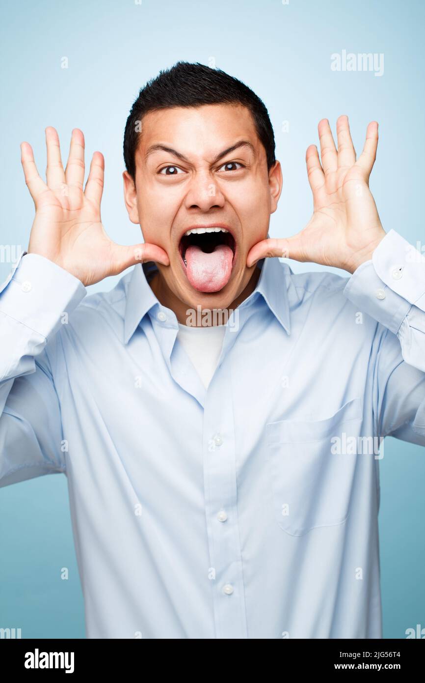 Being crazy isnt a bad thing. Shot of a young man making facial ...