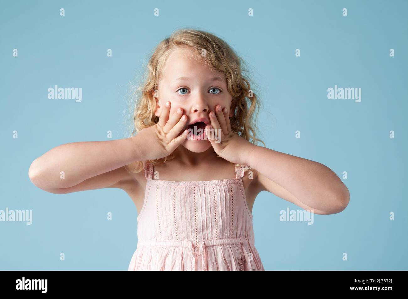 Cute little girl being surprised. Shot of a little girl looking shocked ...