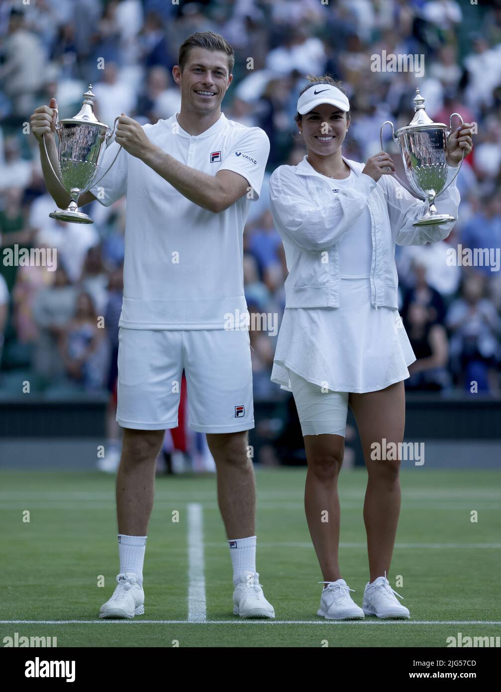 Neal Skupski and Desirae Krawczyk pose with their trophies after ...
