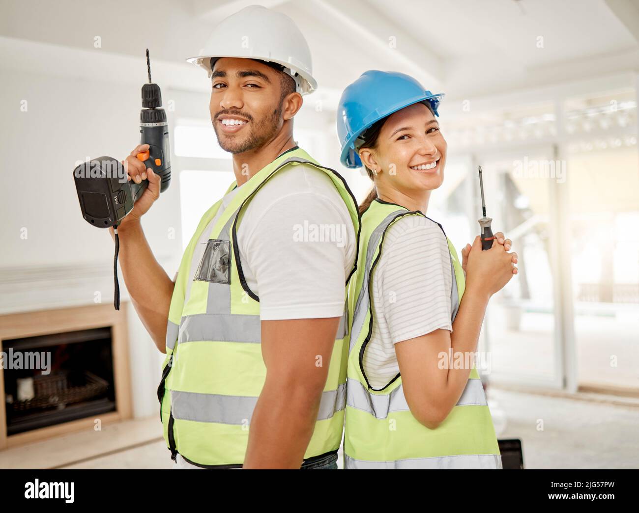 Lets get renovating. Shot of two construction workers standing back to ...