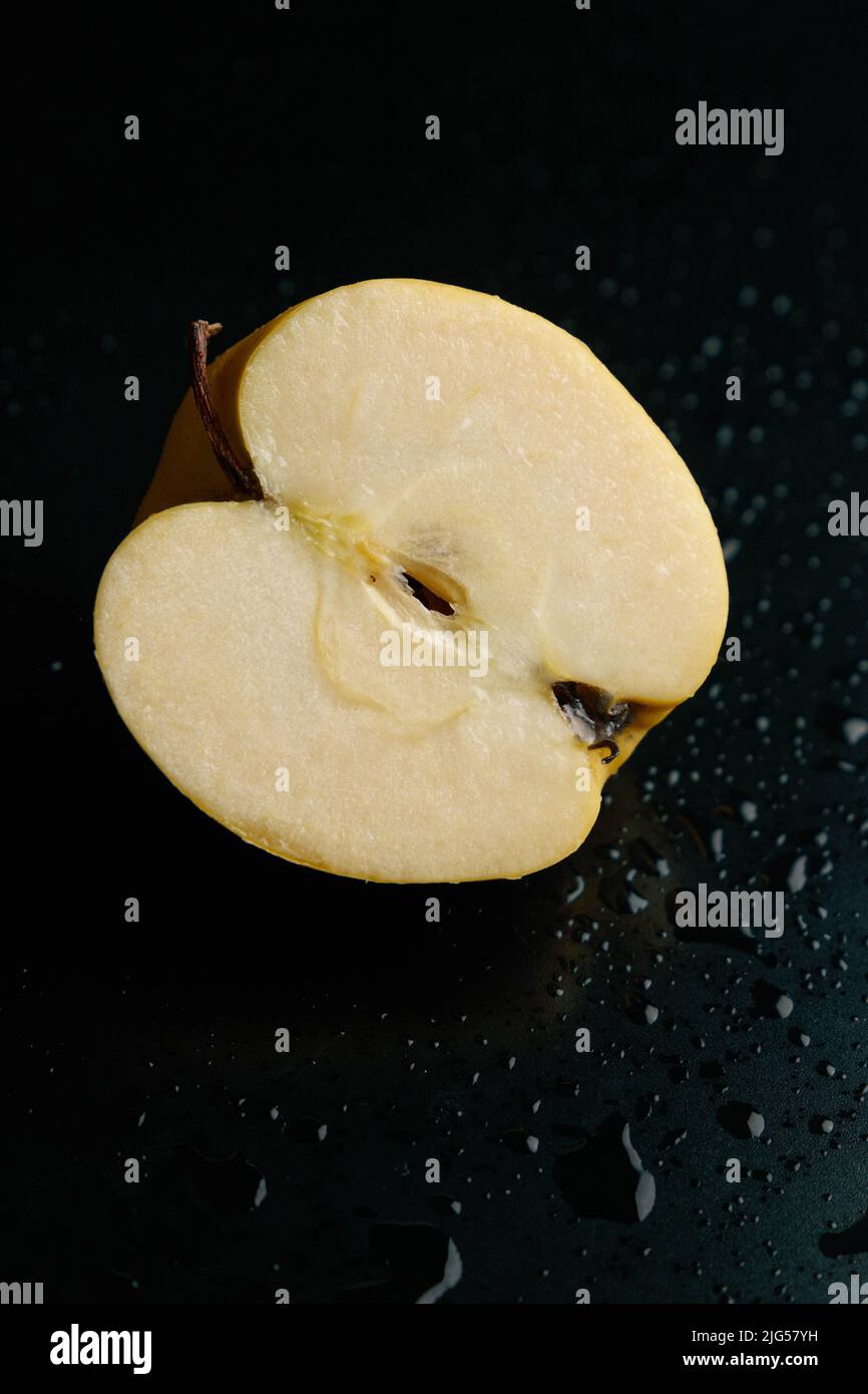 Half of apple on a black background Stock Photo - Alamy