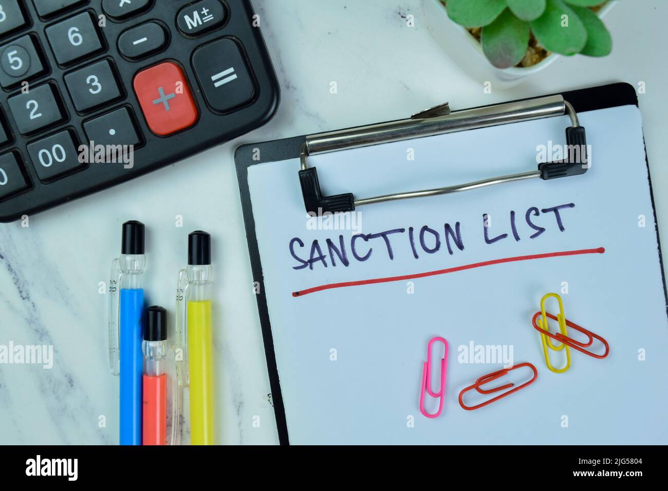 Concept of Sanction List write on a paperwork isolated on Wooden Table ...