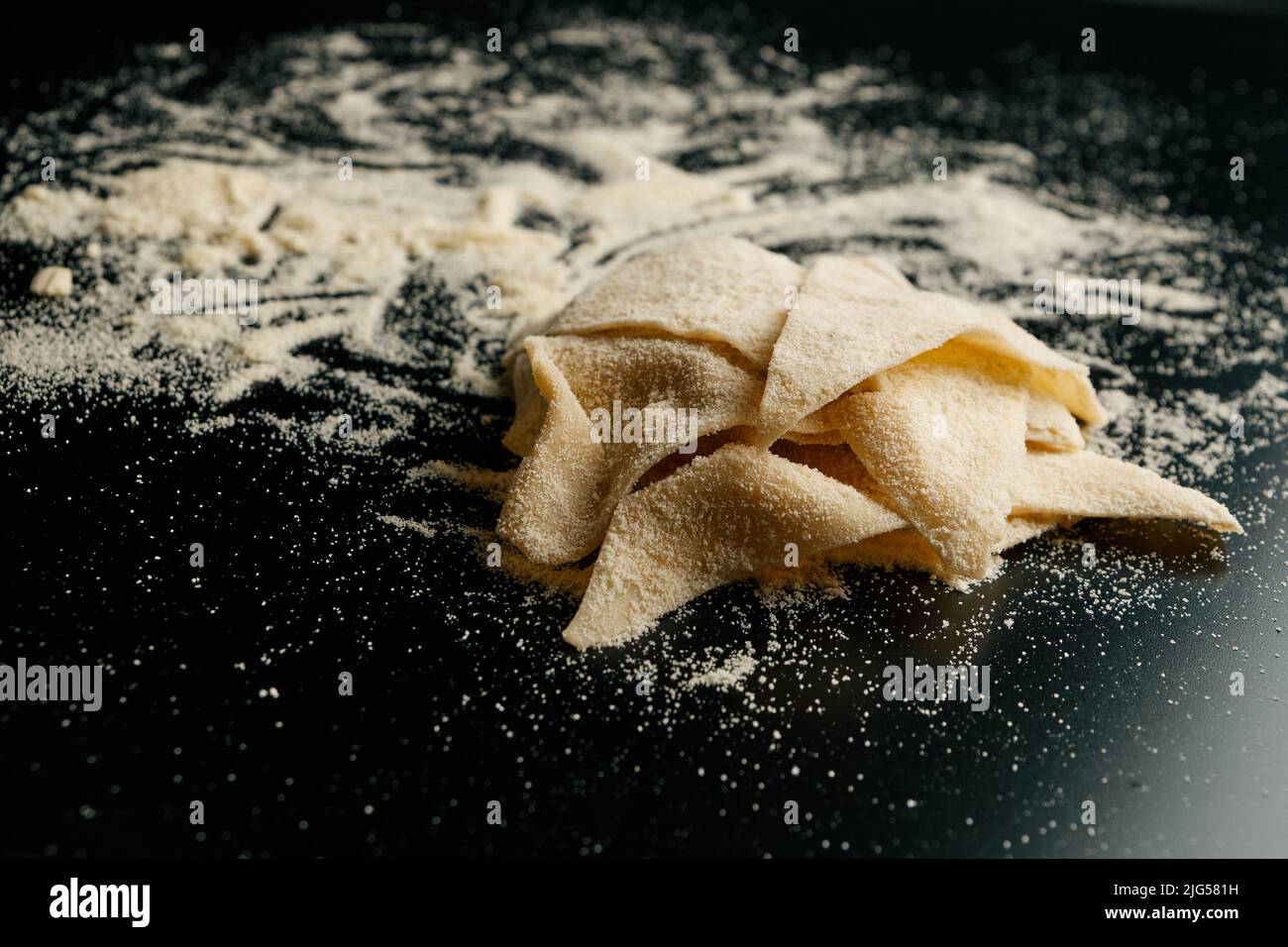 Pasta and flour on black table from italian restaurant Stock Photo - Alamy