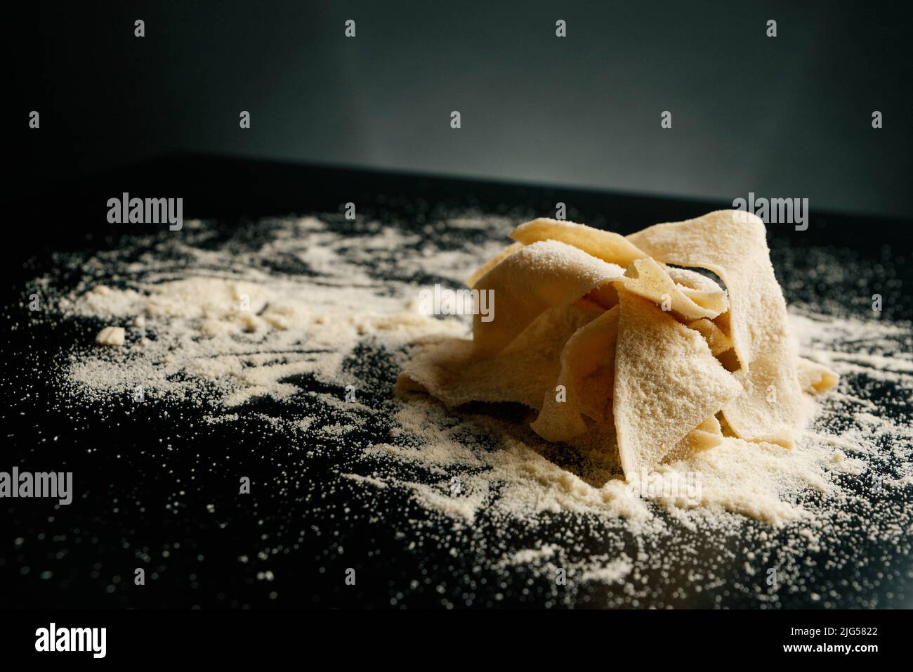 Pasta and flour on black table from italian restaurant Stock Photo - Alamy