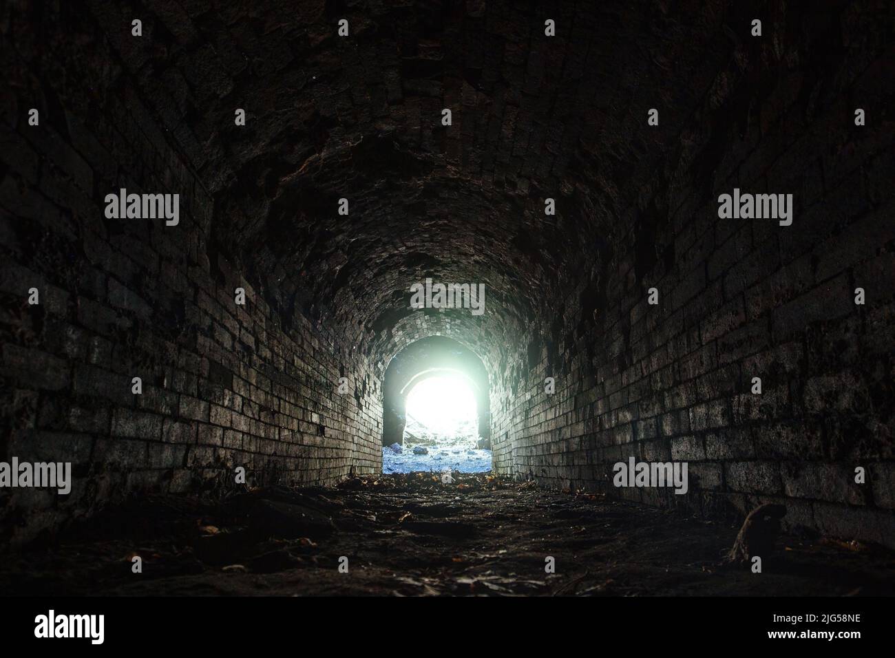 Historical underground red brick passage. Light at the end of tunnel Stock Photo - Alamy