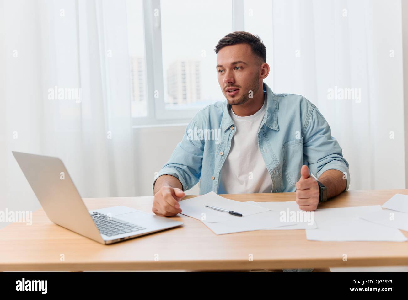Talking happy cheerful smiling good-looking young businessman conducts ...