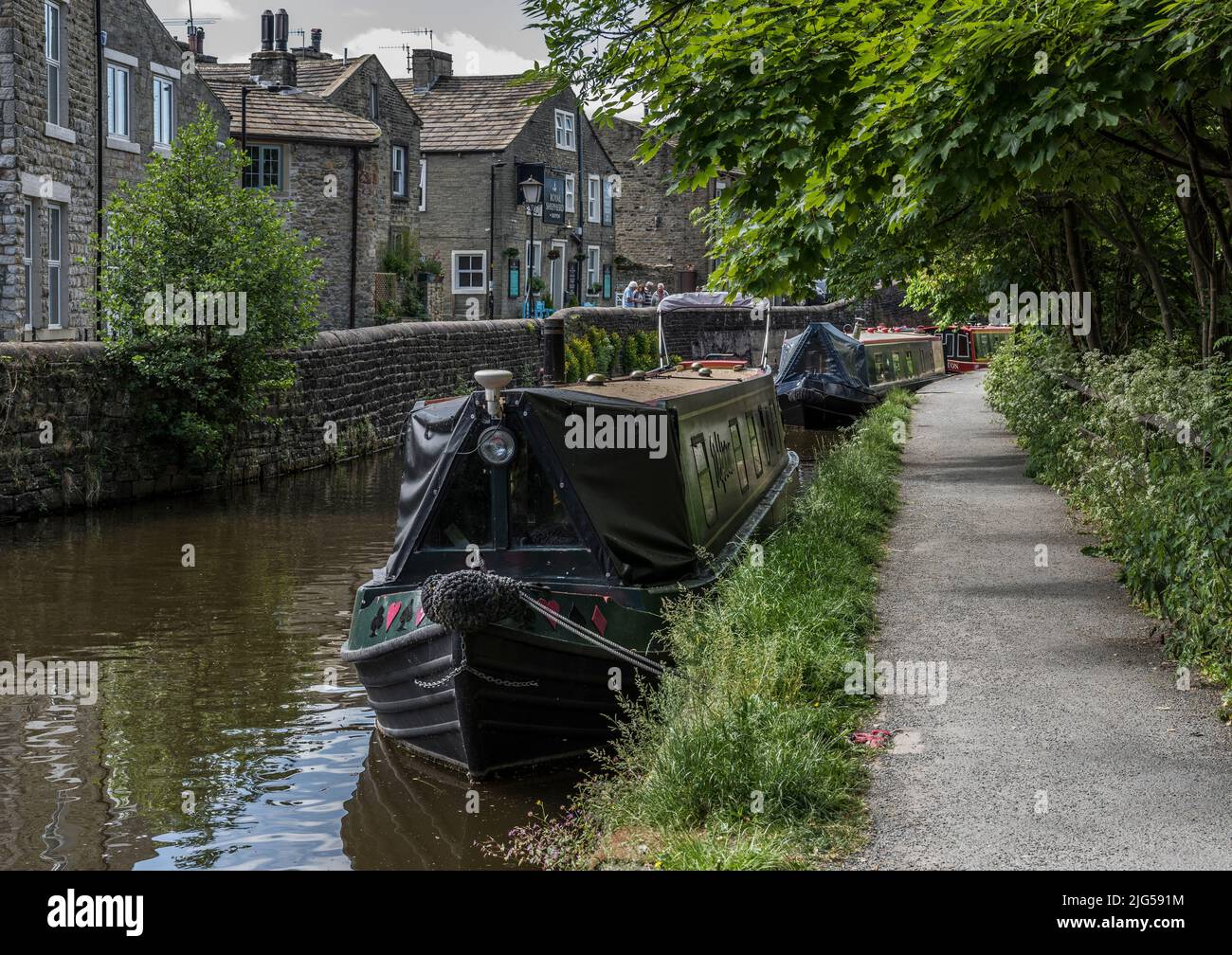 Three narrow boats moored next to the tow path on the Springs Branch of ...