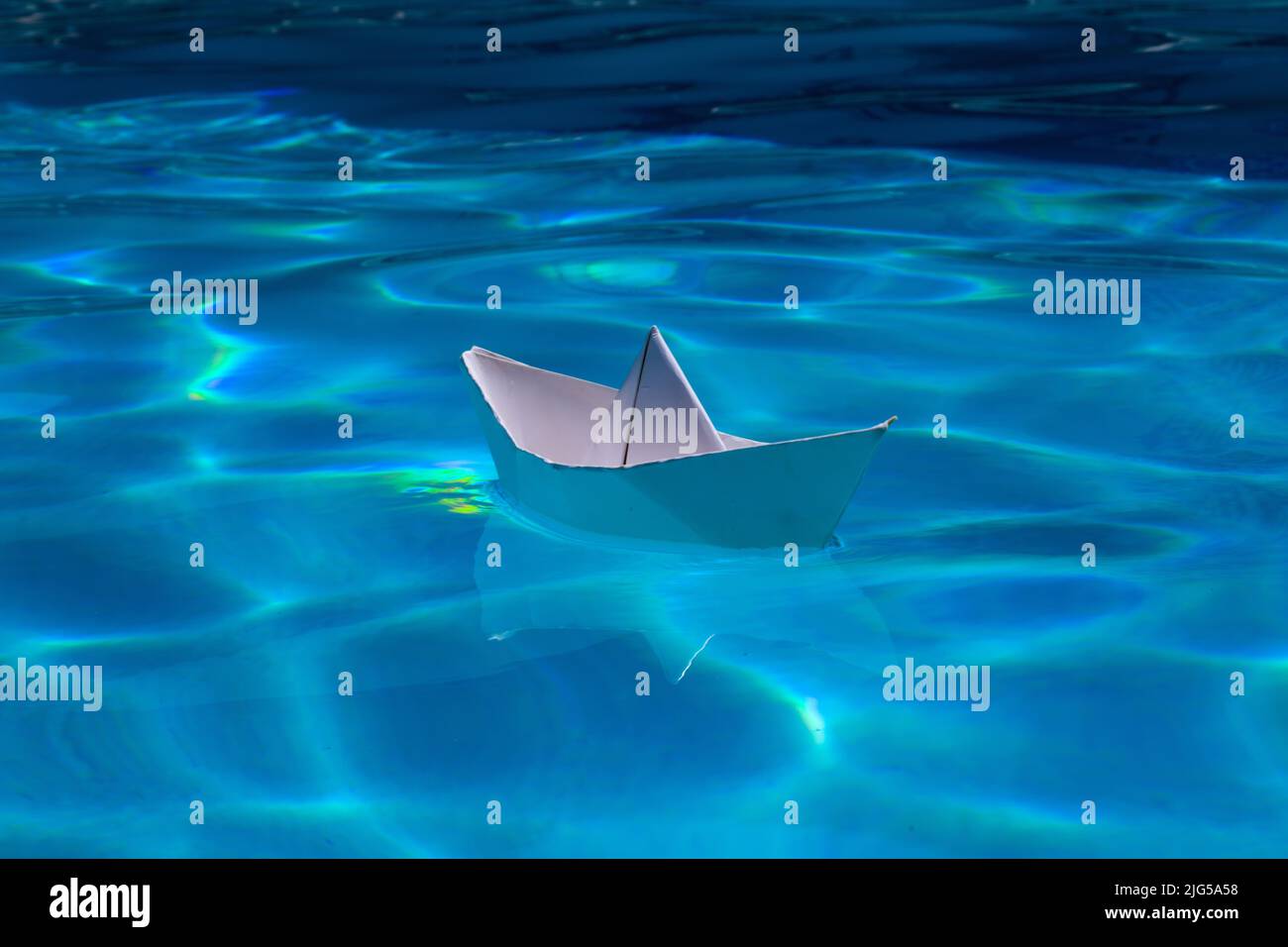 Cruise liner paper art. Paper boat sailing away on sea surface water ...