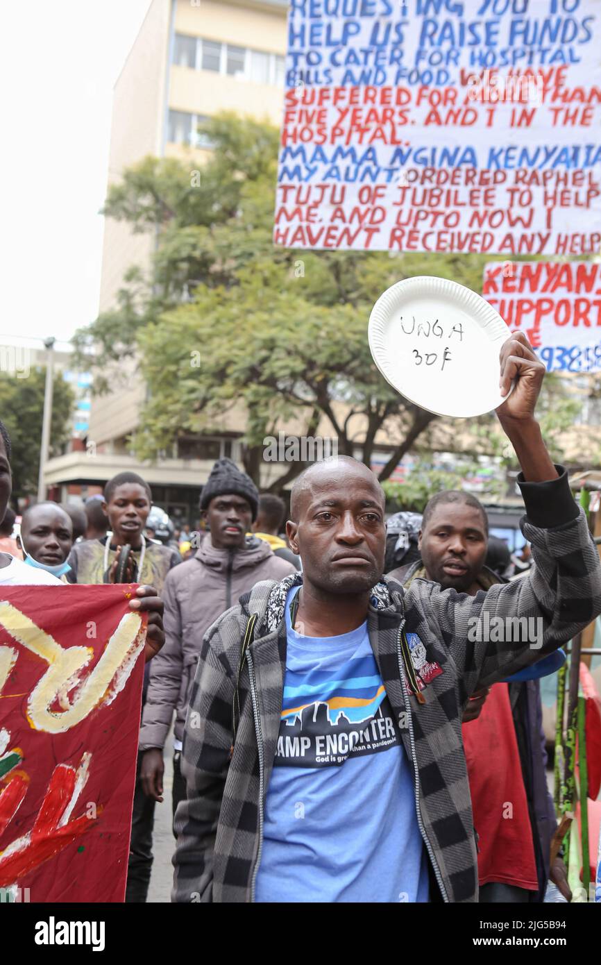Nairobi, Kenya. 07th July, 2022. A Kenyan man displays an empty plate ...