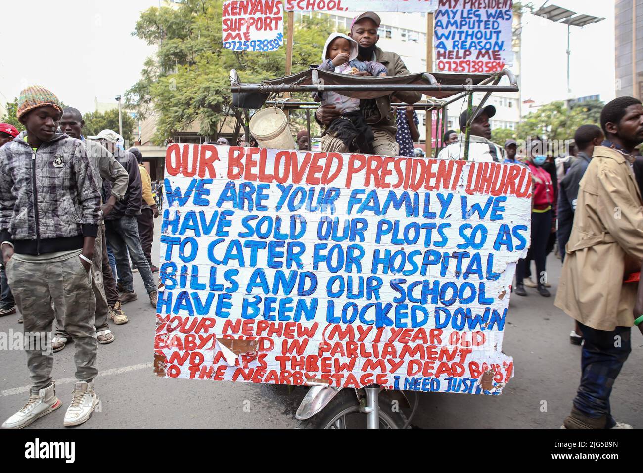 Nairobi, Kenya. 07th July, 2022. A Kenyan man and his son display a ...