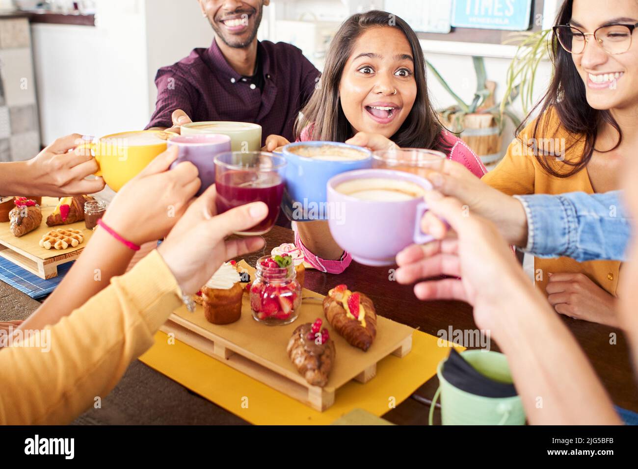 Multicultural People having breakfast drinking coffee and cheers. Happy ...