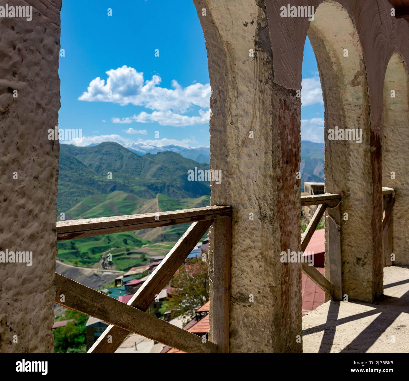 arched gallery along the facade of the house in the ancient mountain ...