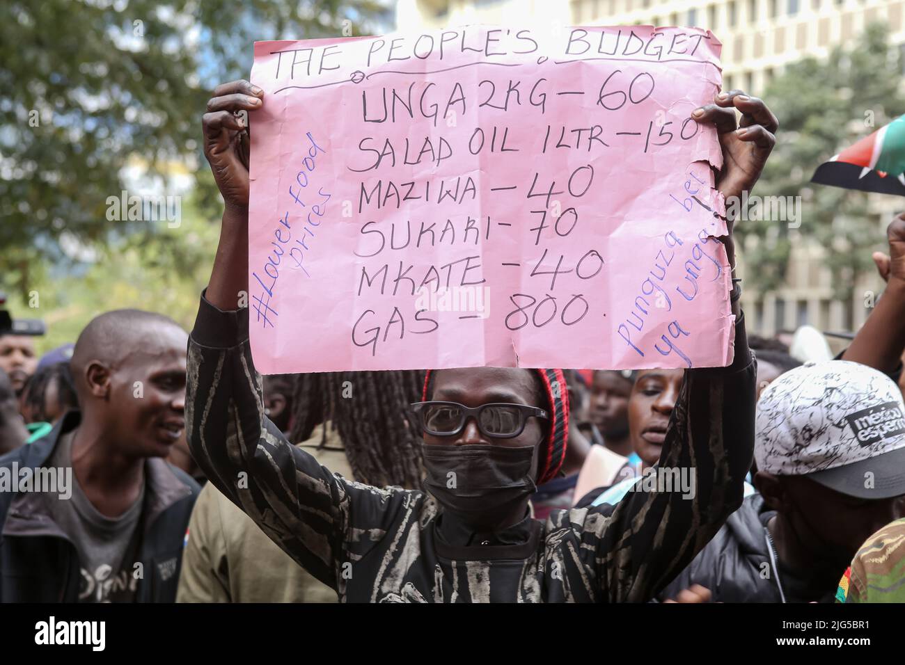Nairobi, Kenya. 07th July, 2022. A Kenyan man holds a placard with the ...