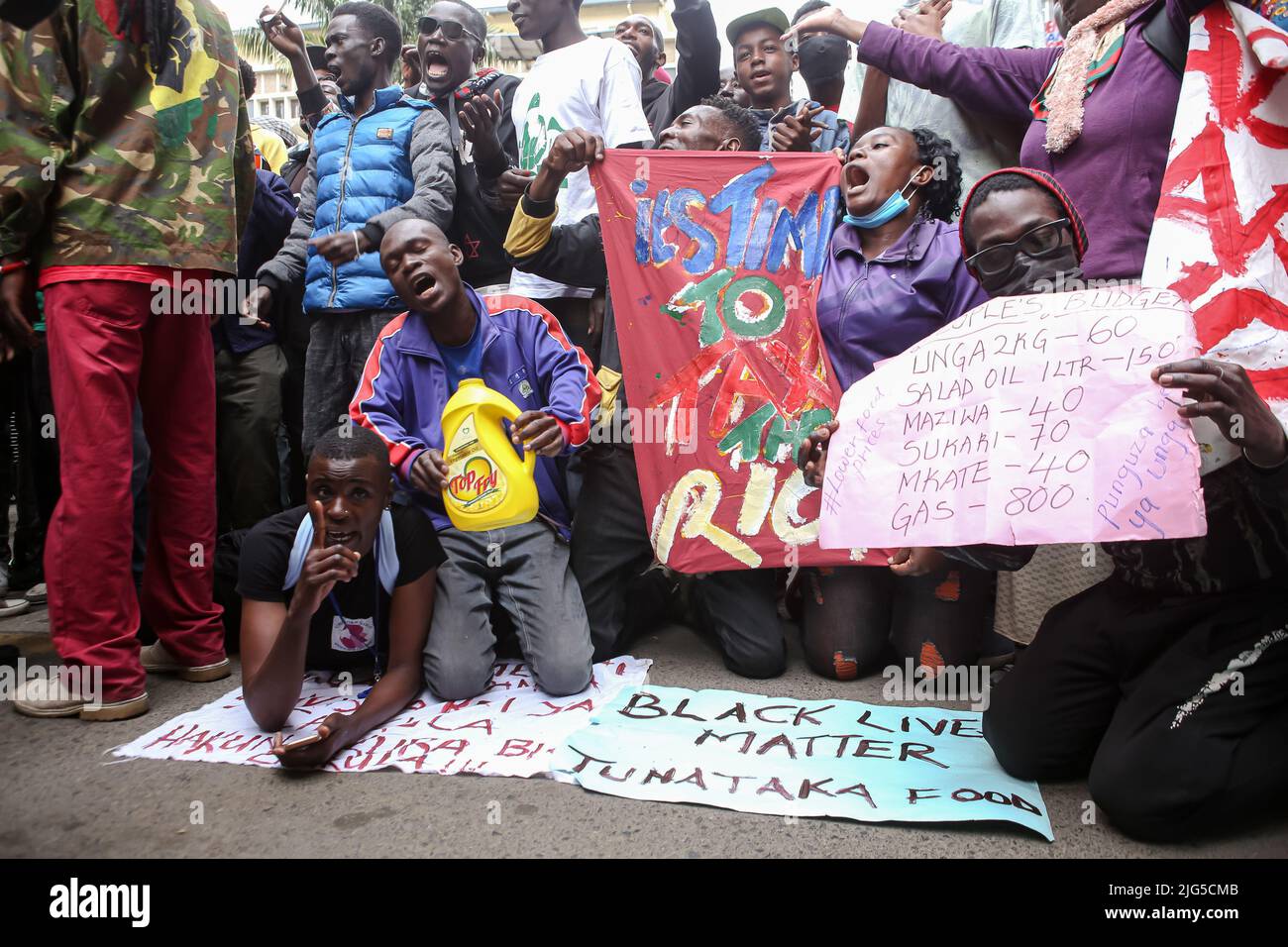 Kenyans shout slogans while holding placards during a march to decry ...