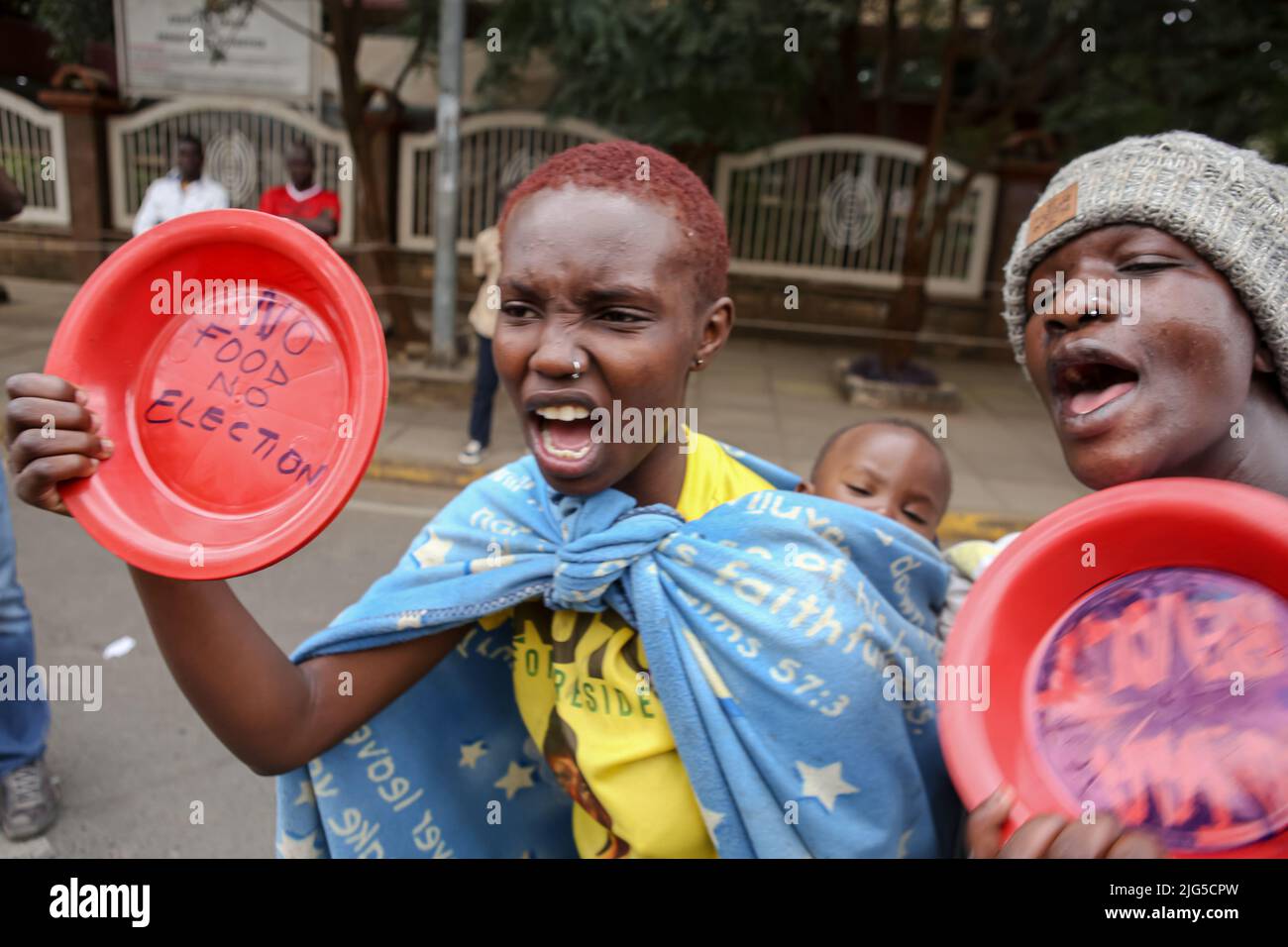 Kenyan women shout slogans and displays empty plates during a march to ...