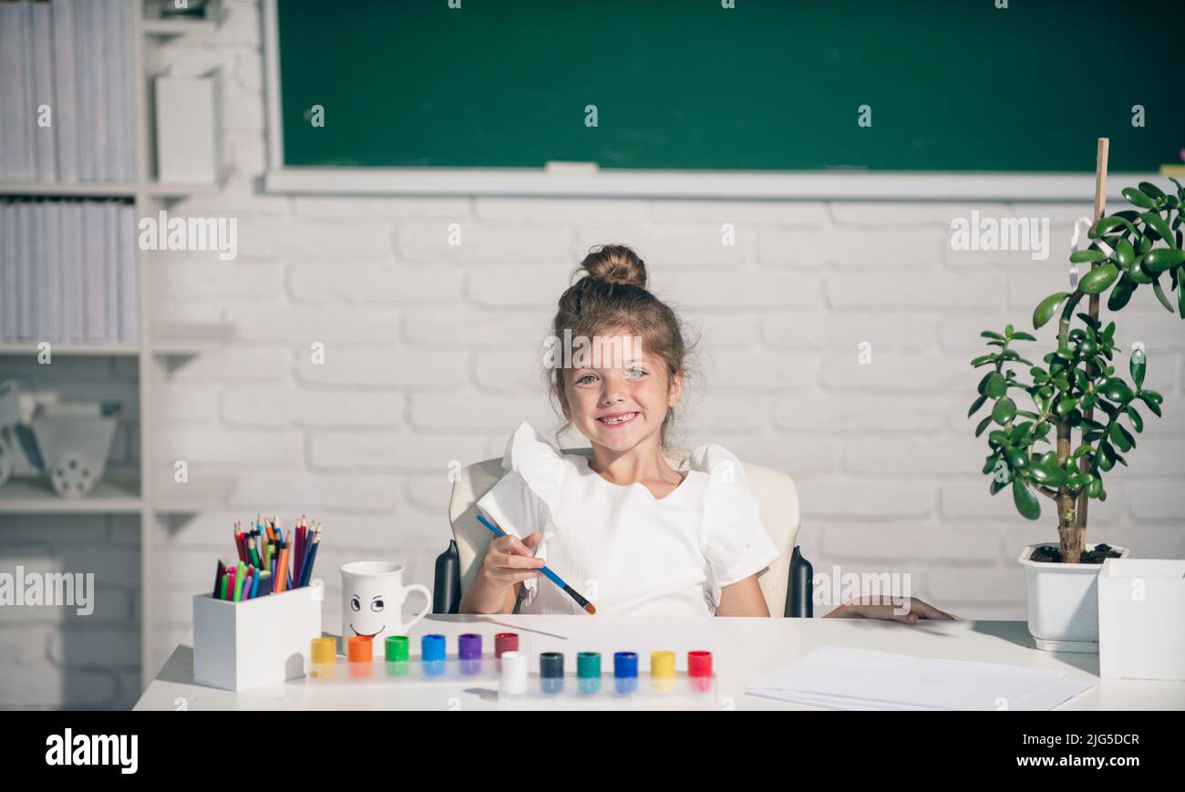 Cute little girl child painting with paints color and brush. Drawing ...