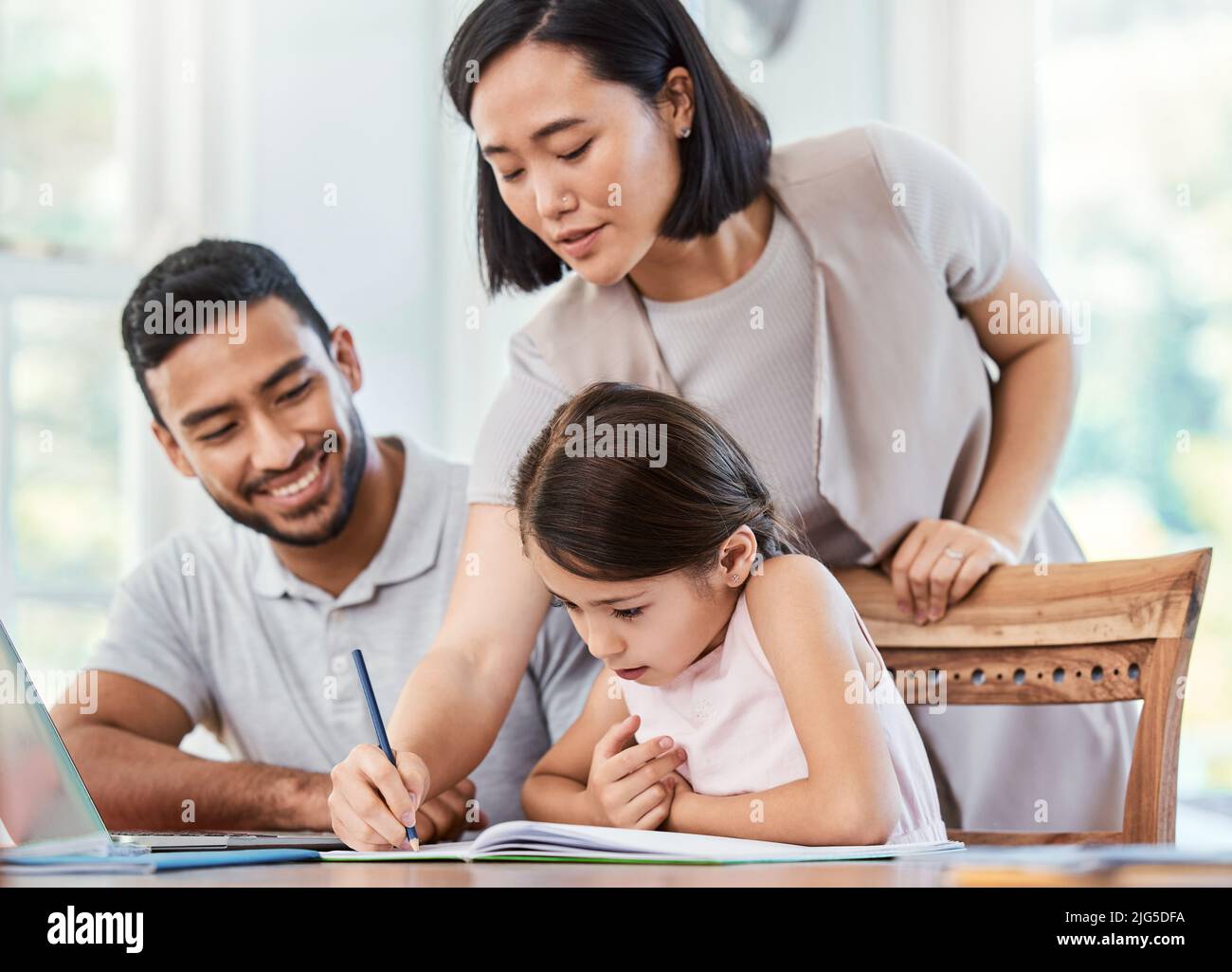 Happiness is having a large, loving family. Shot of young parent helping their daughter with ...