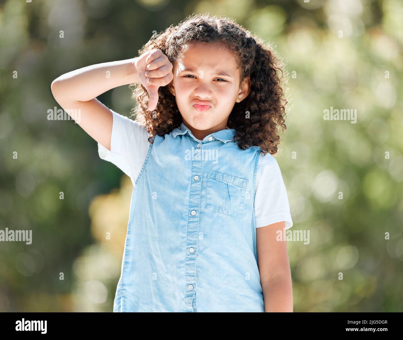 I wish I had someone to play with. Shot of a little girl sulking while ...