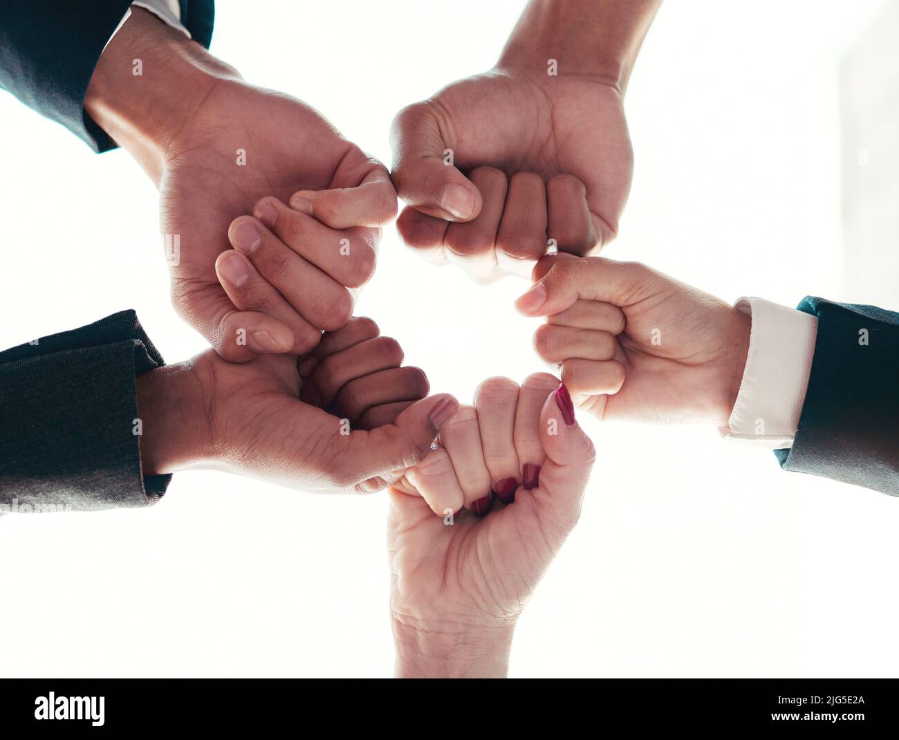Together we can do so much more. Low angle shot of a group of unrecognizable businesspeople ...