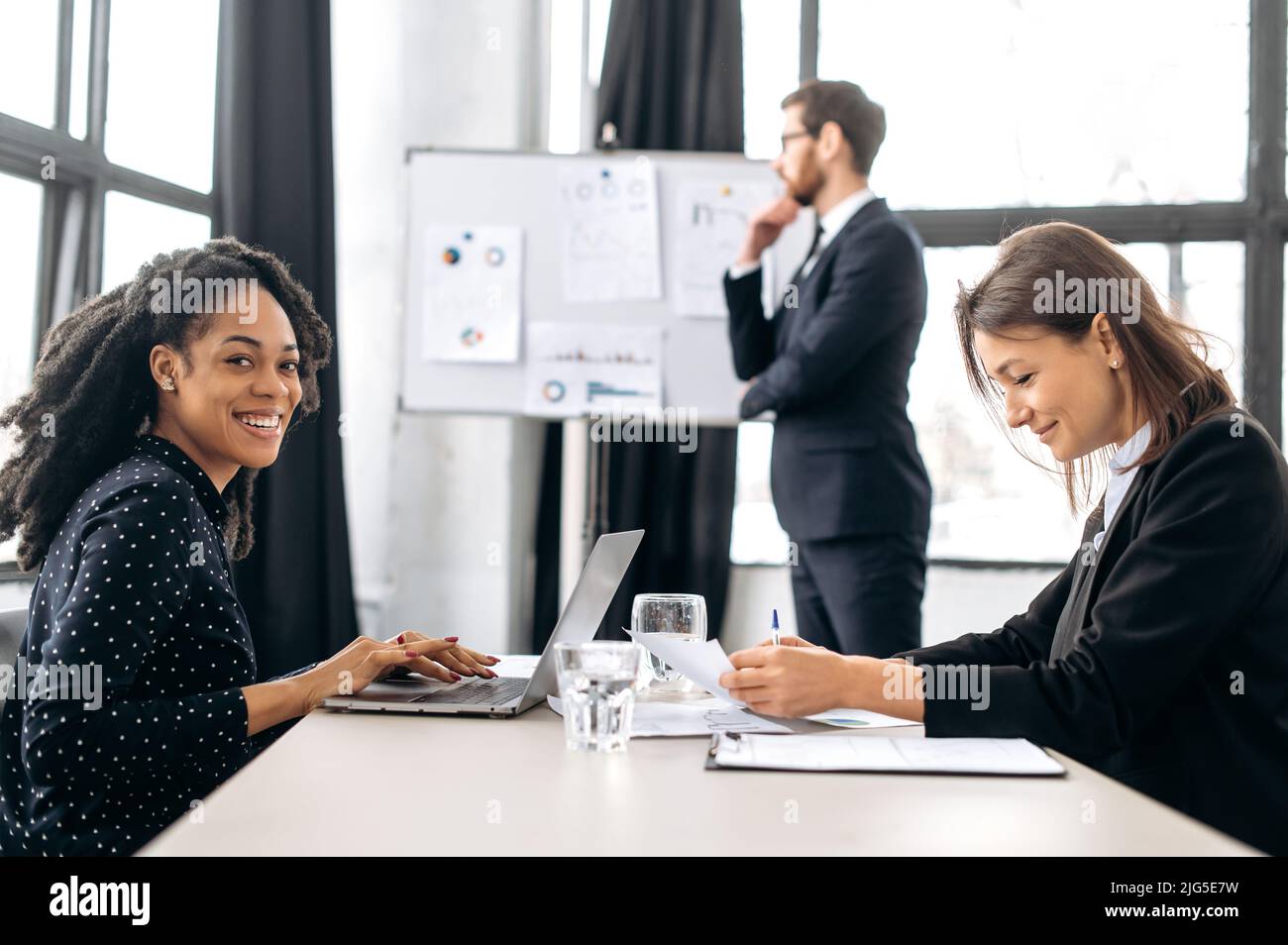 Pretty african american successful business woman, sits at work desk in ...