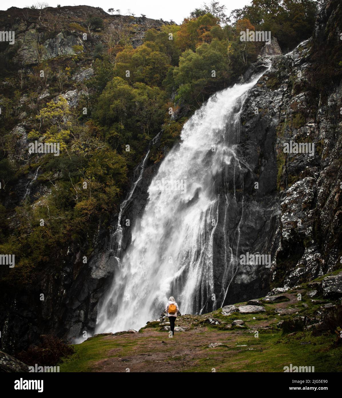 Backpacker Girl exploring Aber waterfalls in Snowdonia National Park UK ...