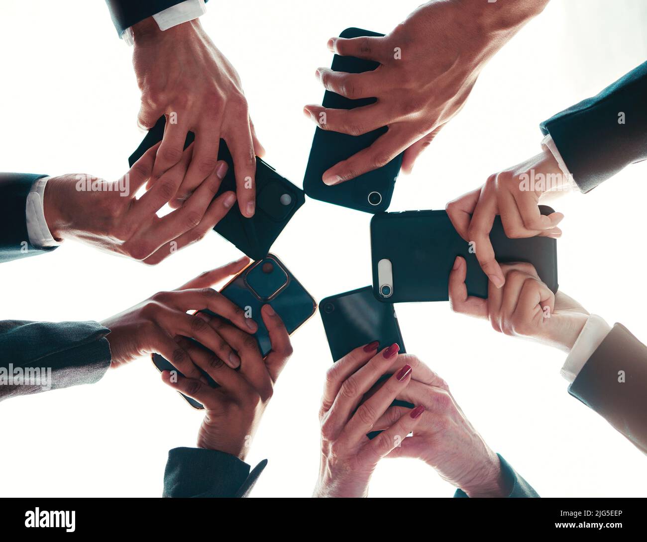 Connectivity. Low angle shot of a group of unrecognisable ...