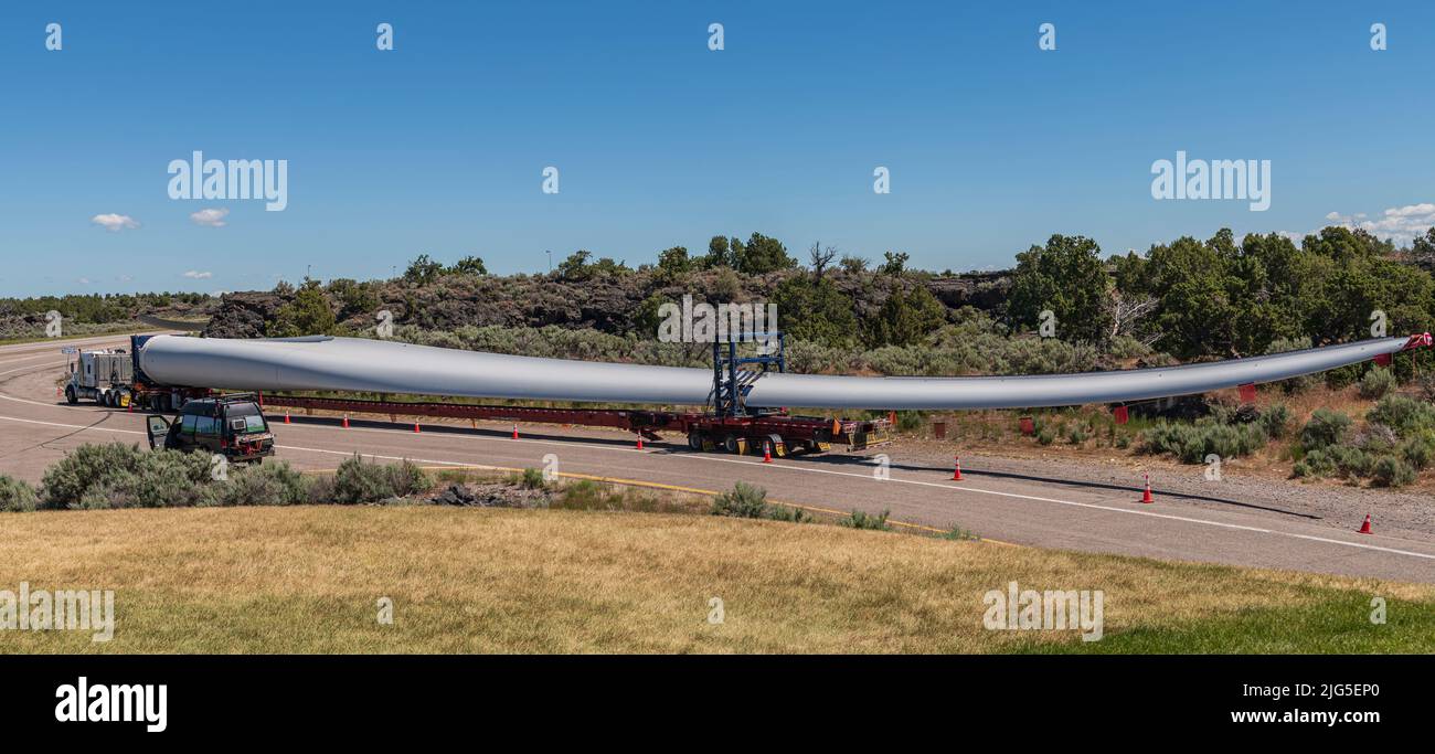 Single long wind turbine blade on a truck resting at a rest area in ...
