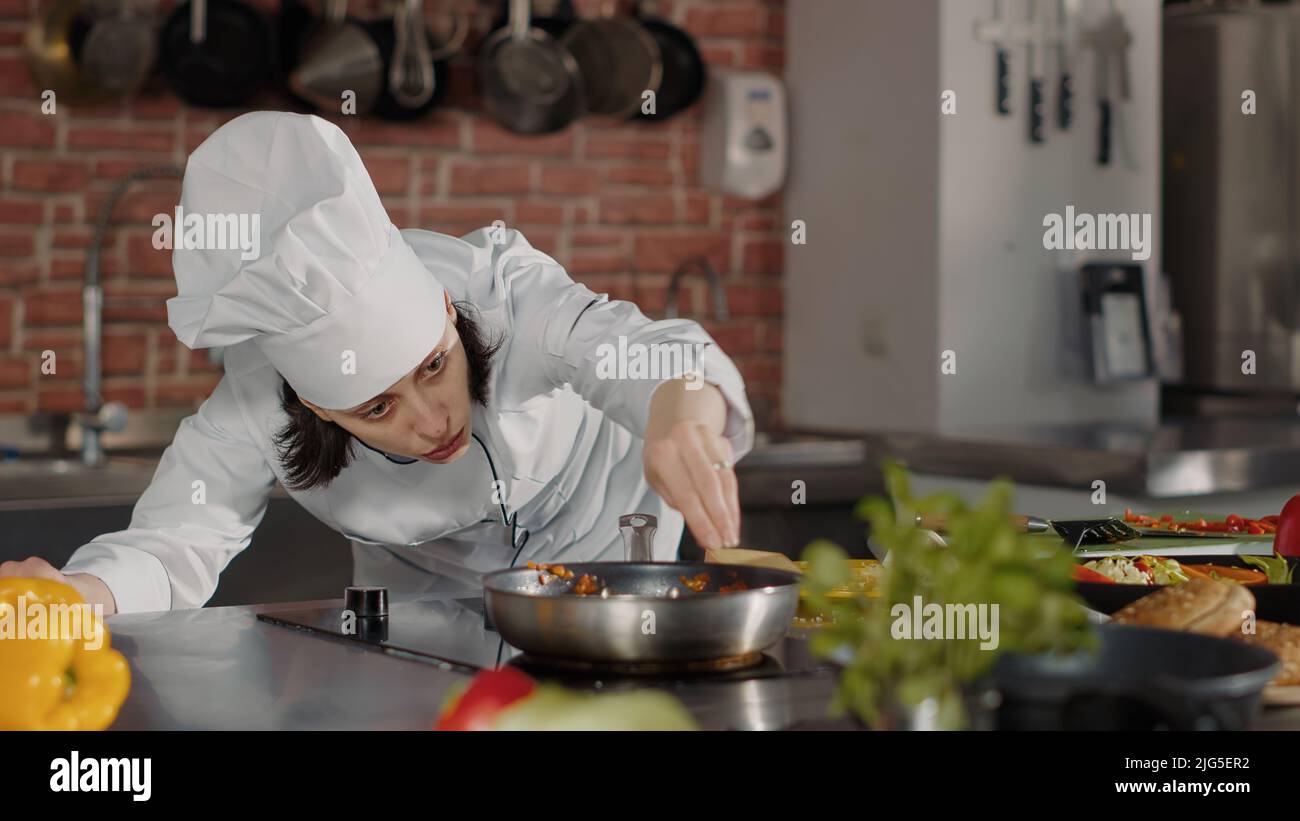 Professional chef adding grated parmesan hi-res stock photography and ...