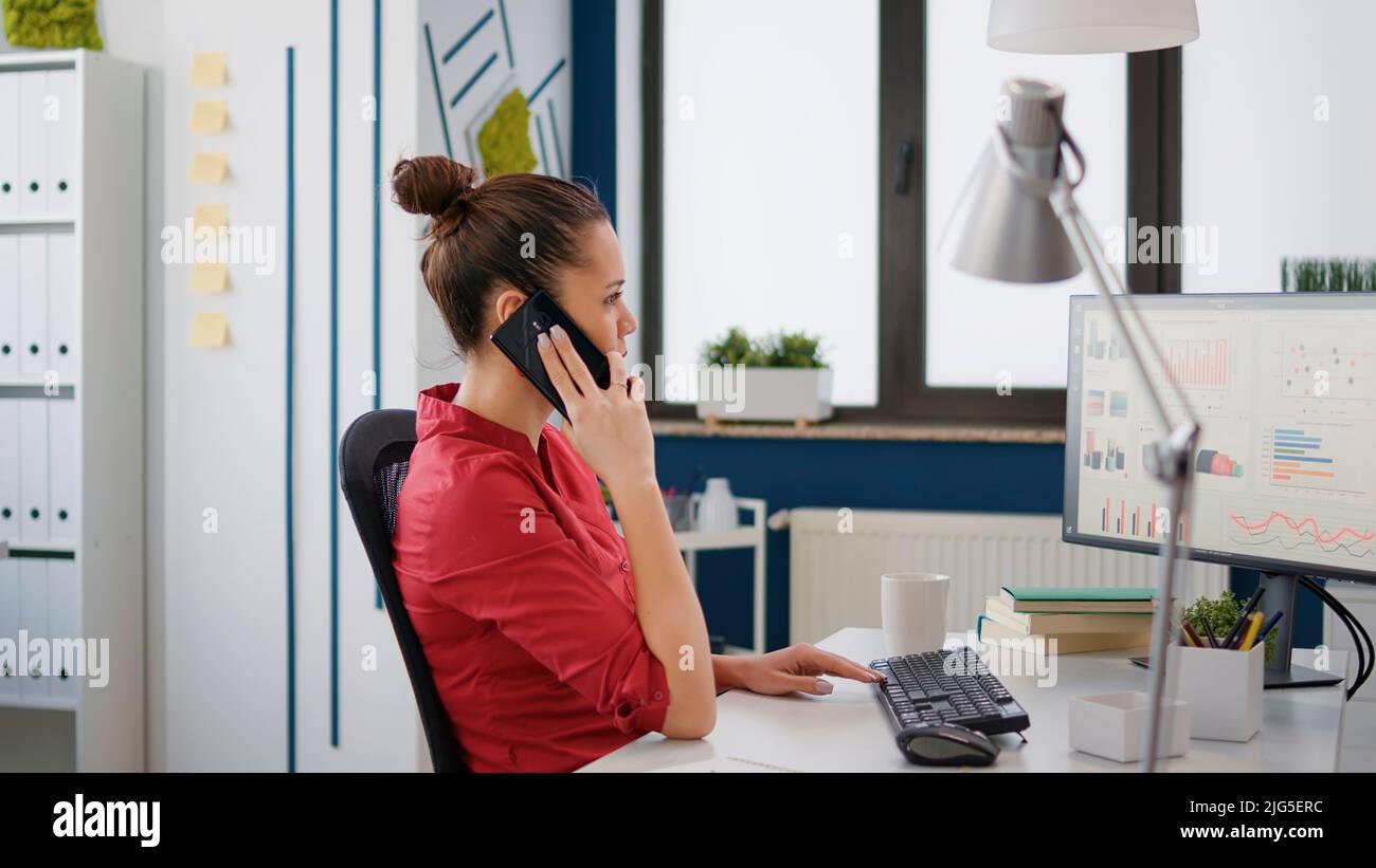 Executive manager using smartphone to call consultant, doing work ...