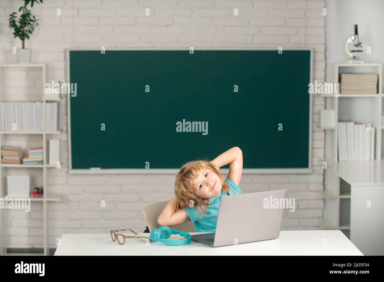 Cute little child using laptop computer, kid boy studying through ...