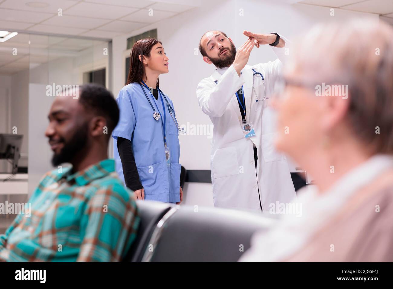Diverse medical staff talking about healthcare service in hospital ...