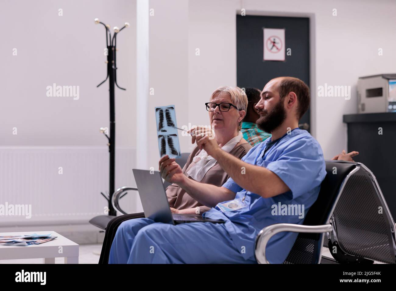 Receptionist talking appointment elderly hi-res stock photography and ...