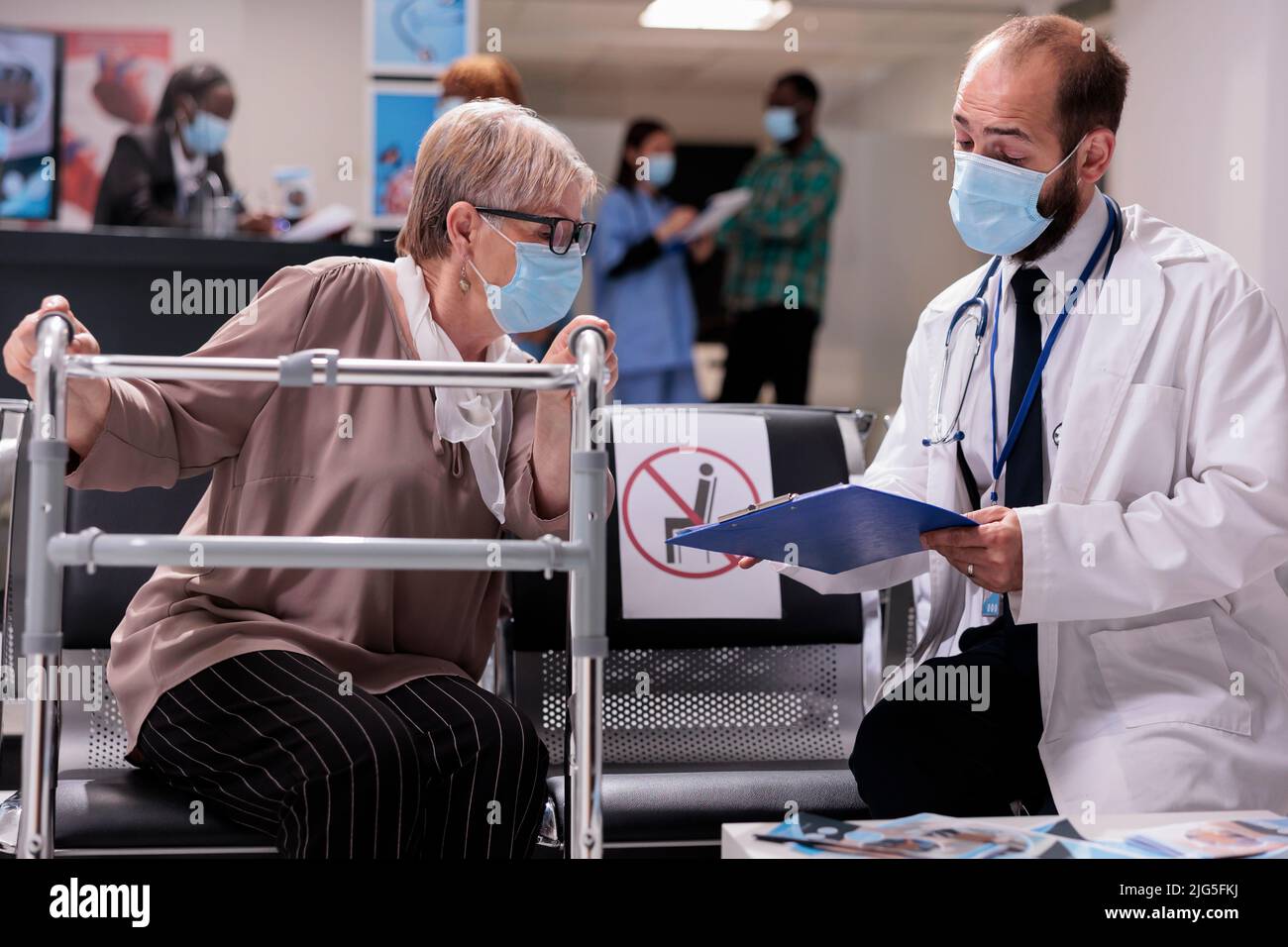 Senior woman with disability in waiting room lobby doing checkup ...