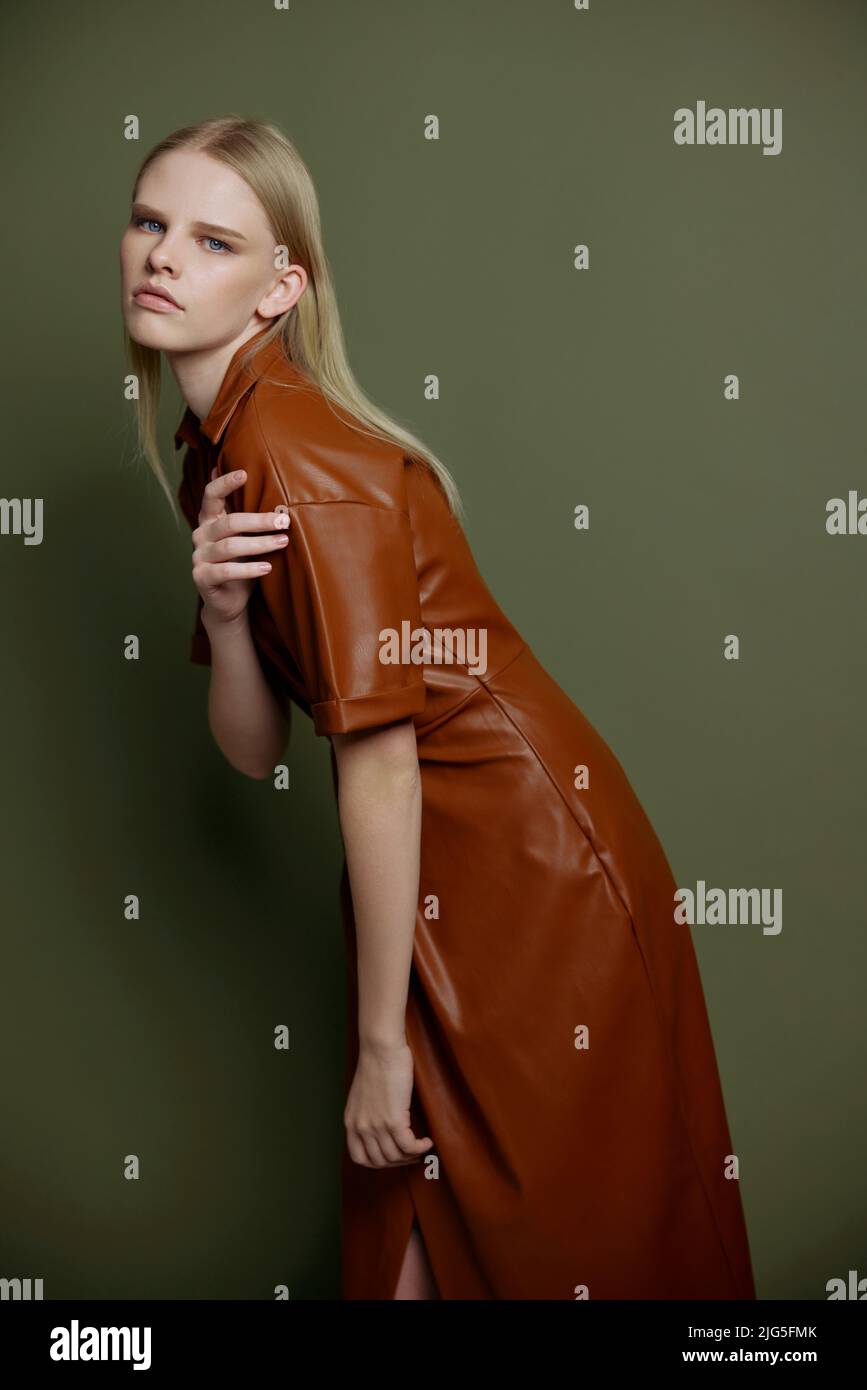 Stylish young blonde model with blue eyes and evening makeup posing in ...