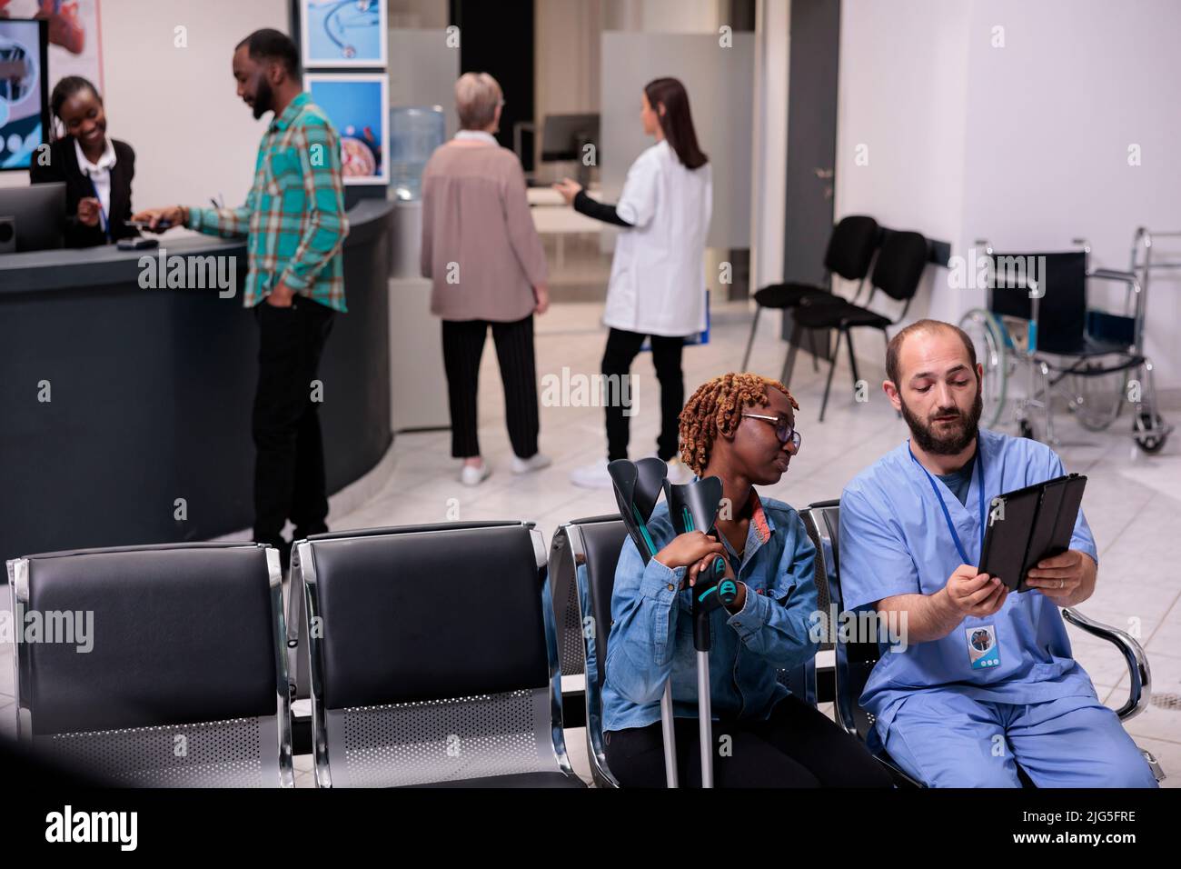 African american patient and nurse looking at tablet to find dsease ...