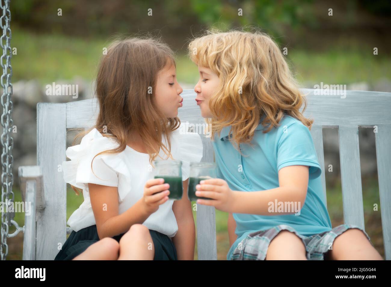 Hugging and kissing kids couple. Little lovely children outdoor ...